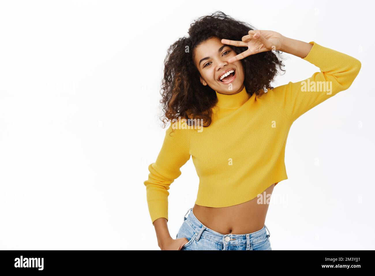 Happy beautiful african girl showing peace, v-sign, optimistic pose ...