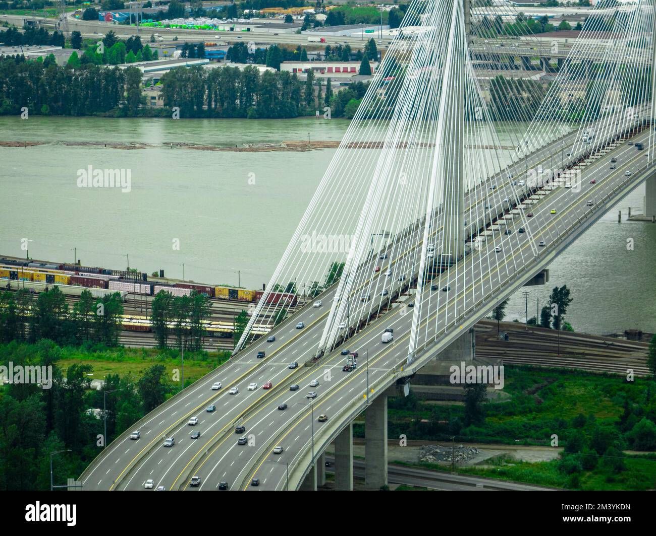 A high-angle shot of the Port Mann Bridge, busy during the day in ...