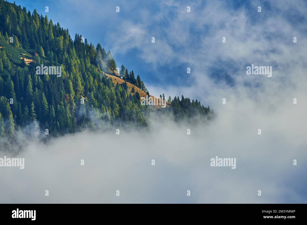 Clouds lying in the valley between Mountains at Hochalpenstrasse ...