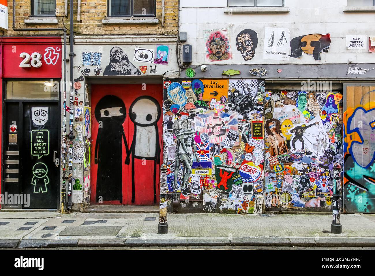 Paste-up street art with Stick mural, Princelet Street, Shoreditch ...