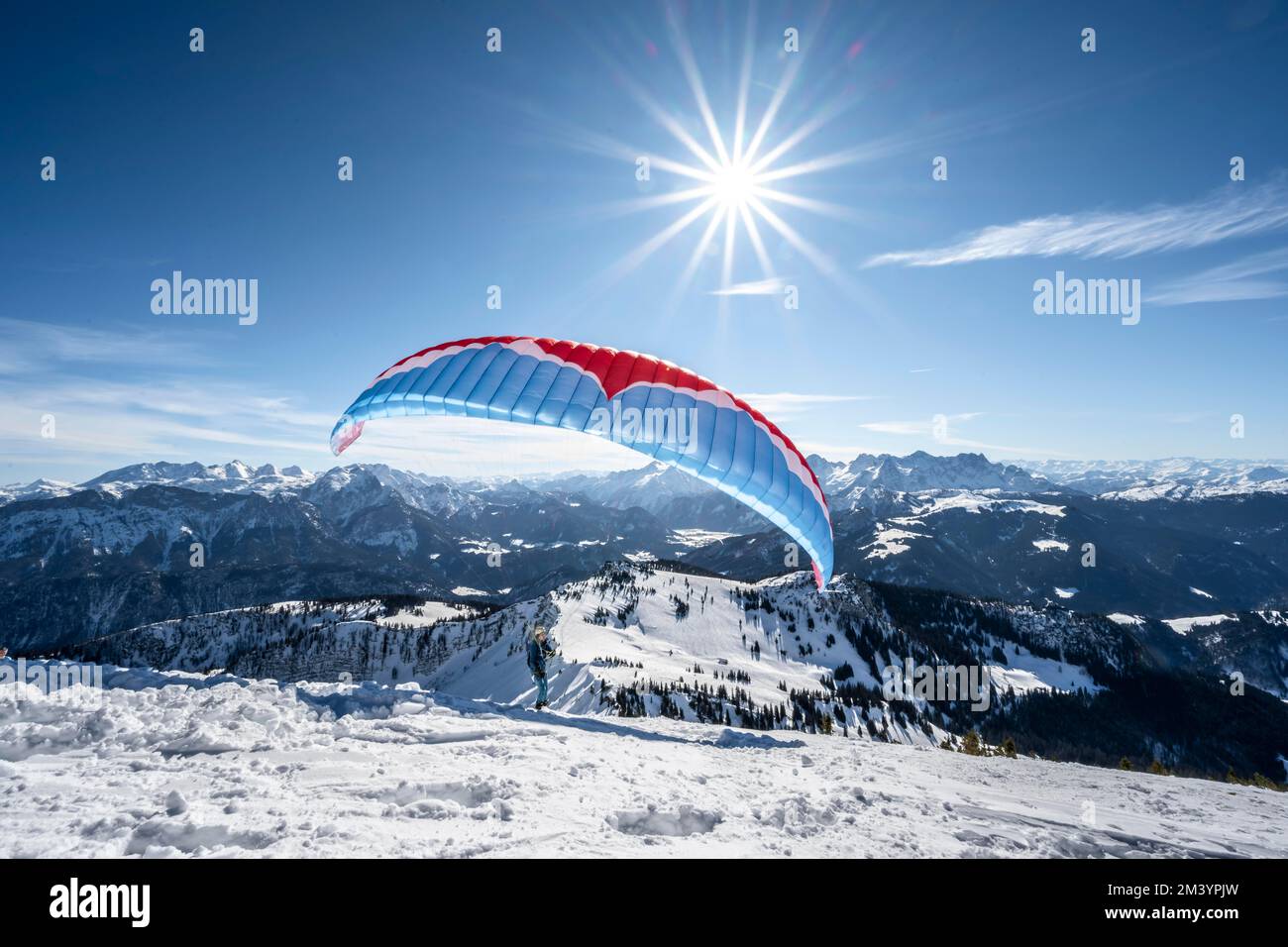 Paraglider at take-off in winter, summit of Sonntagshorn, mountain ...