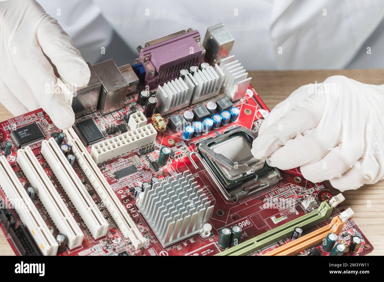 Elevated view technician working computer motherboard Stock Photo - Alamy