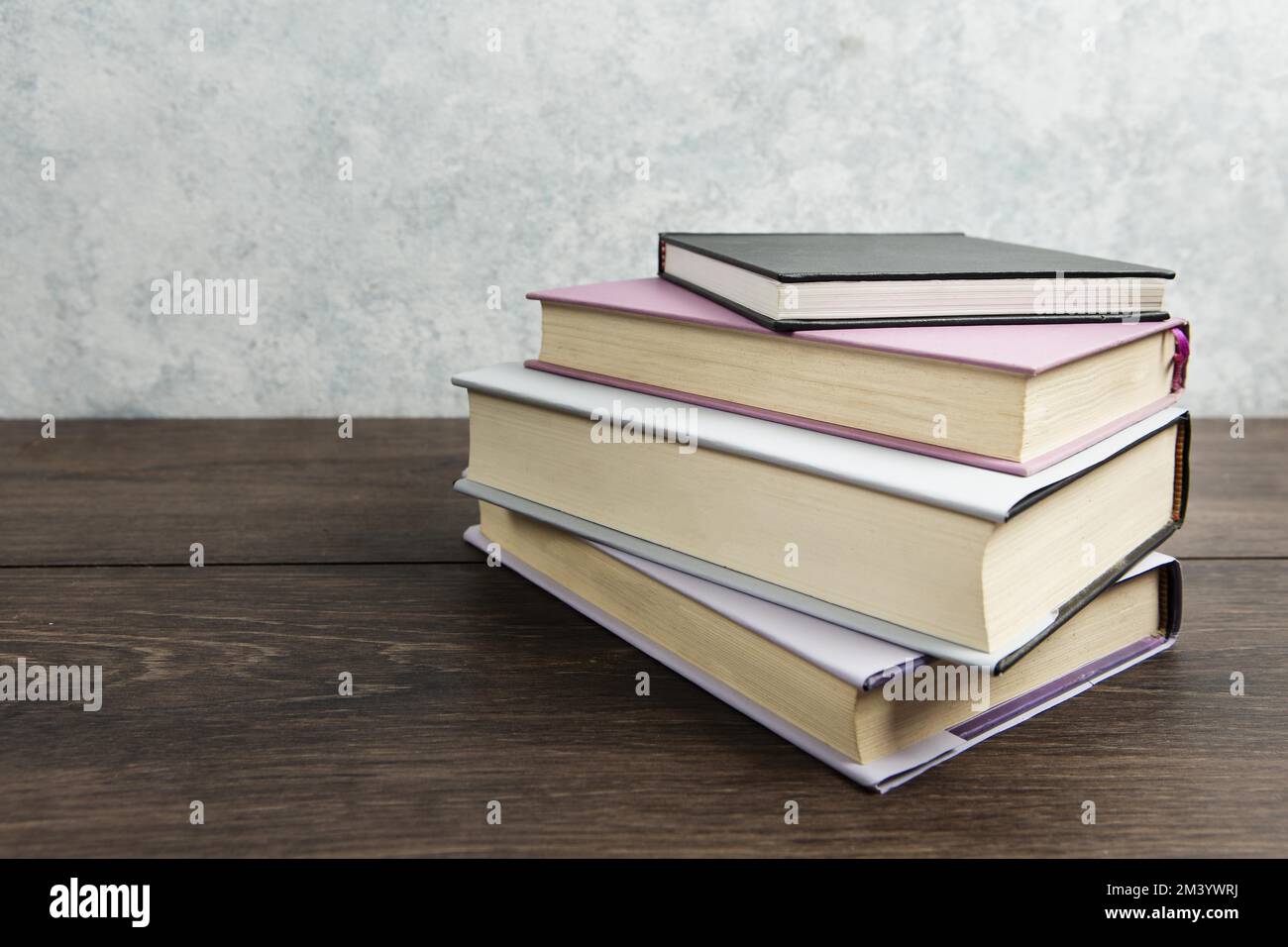 Front view book arrangement wooden table Stock Photo - Alamy