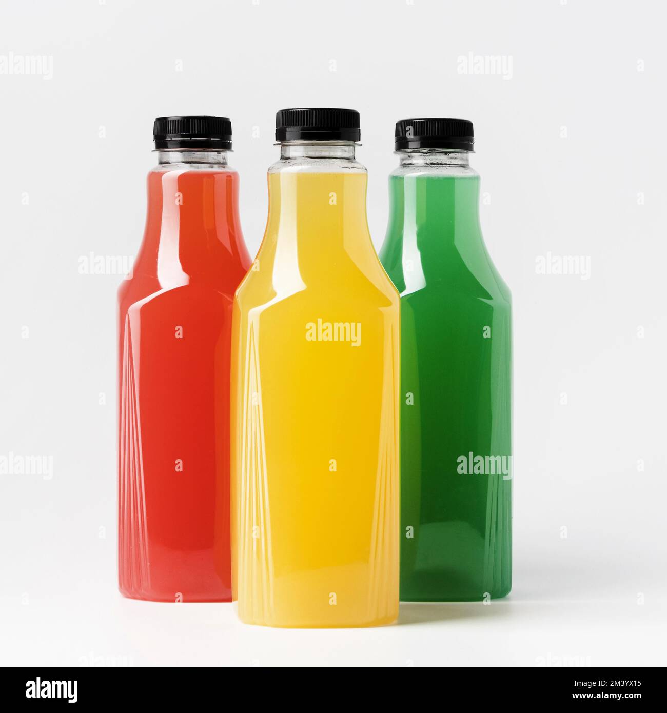Front view three juice bottles with cap Stock Photo - Alamy
