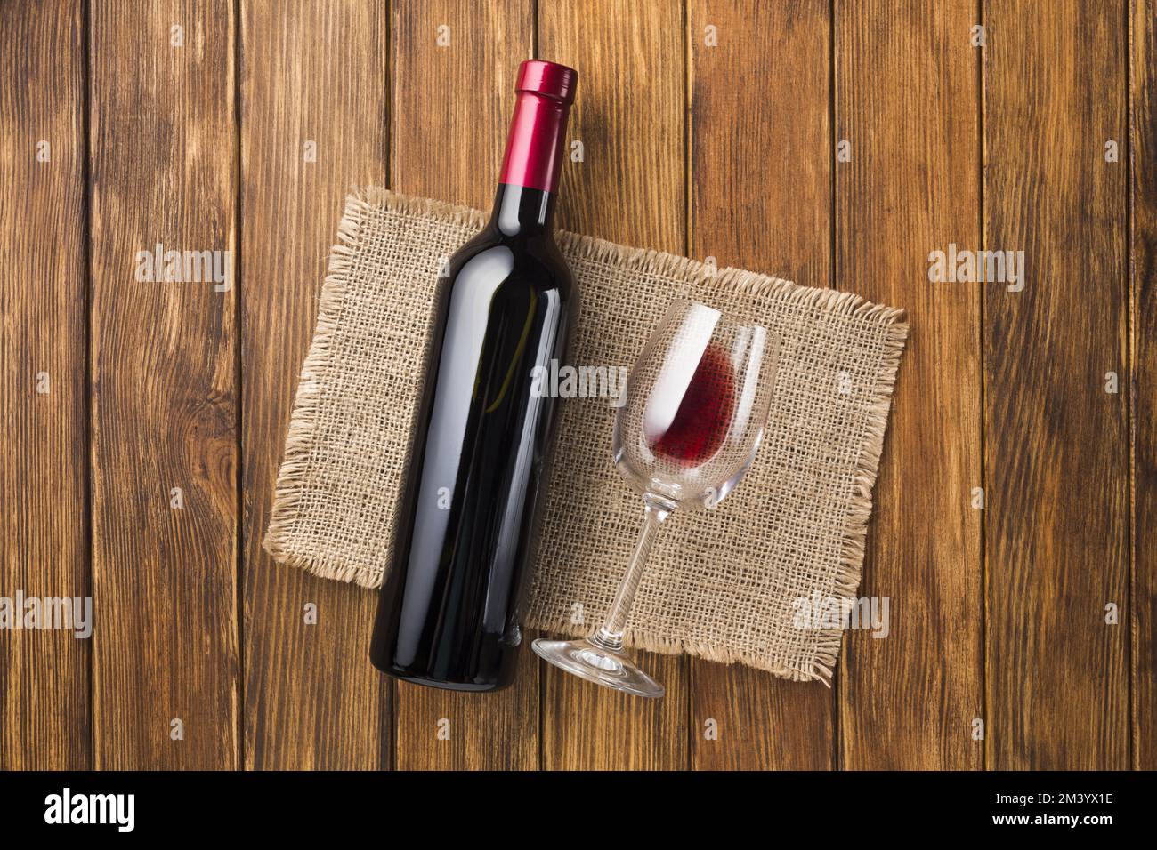 Full bottle red wine empty glass Stock Photo - Alamy