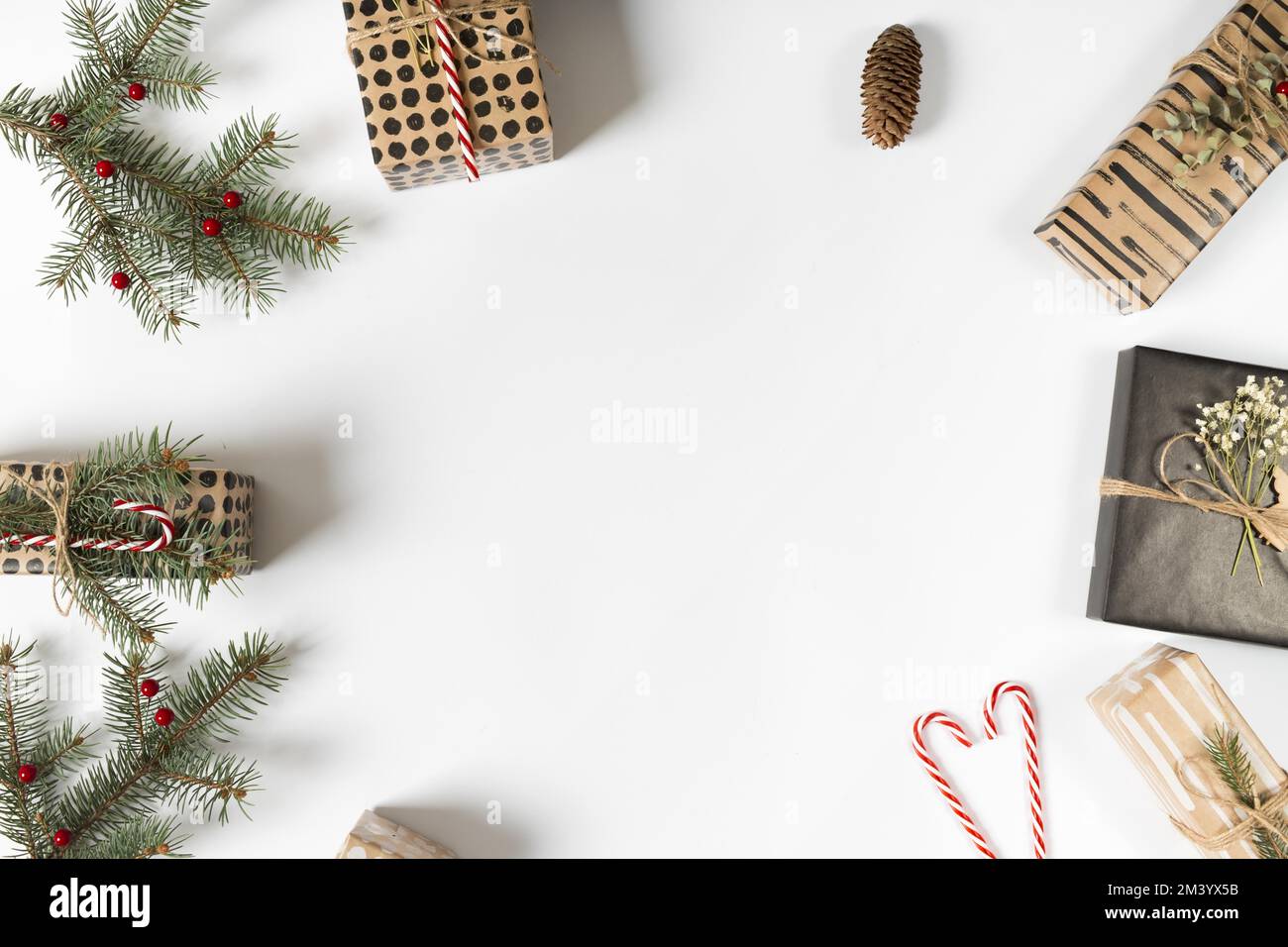 Gift boxes with green branches candy canes Stock Photo - Alamy