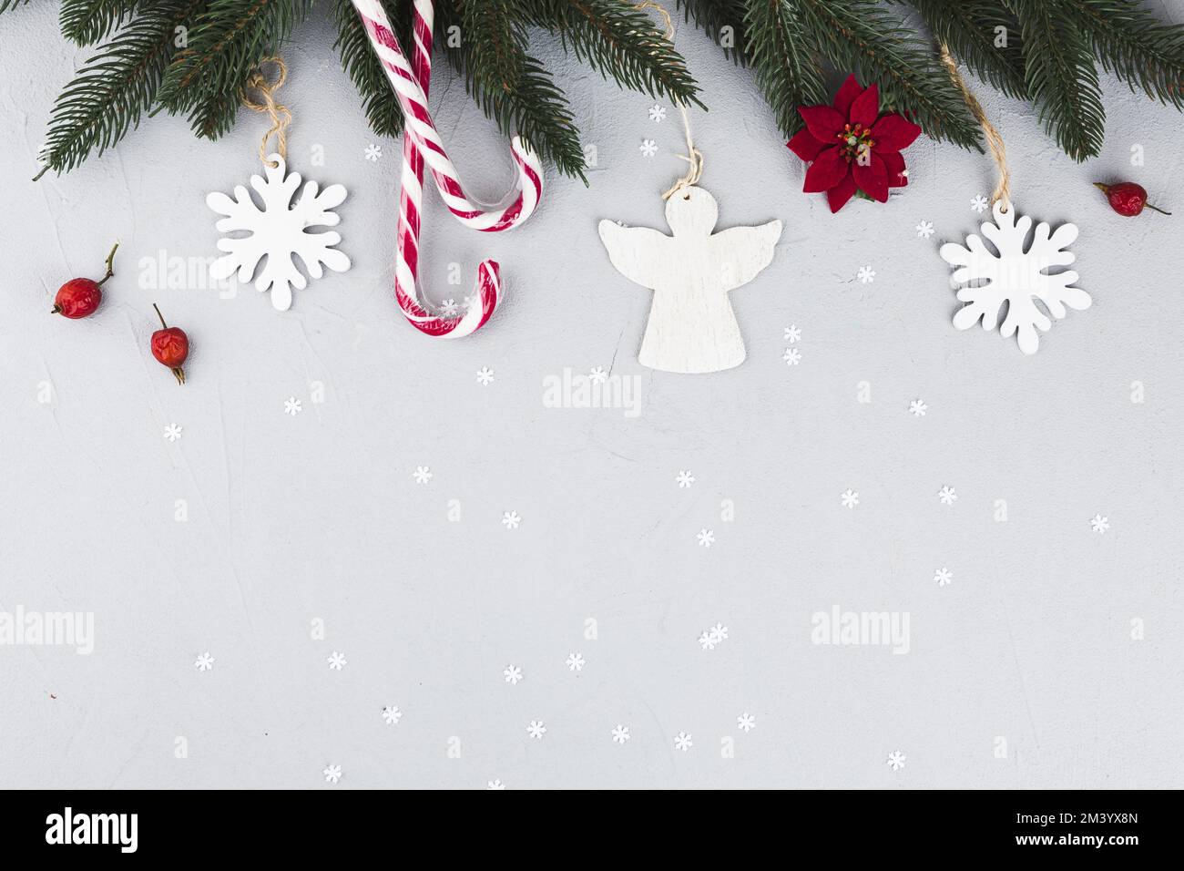 Green fir tree branches with candy canes toys Stock Photo - Alamy