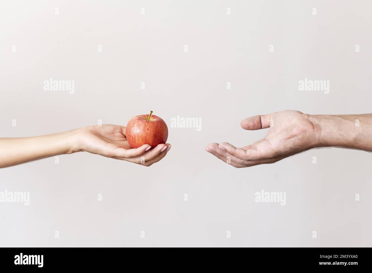 Hand giving apple fruit needy person Stock Photo - Alamy