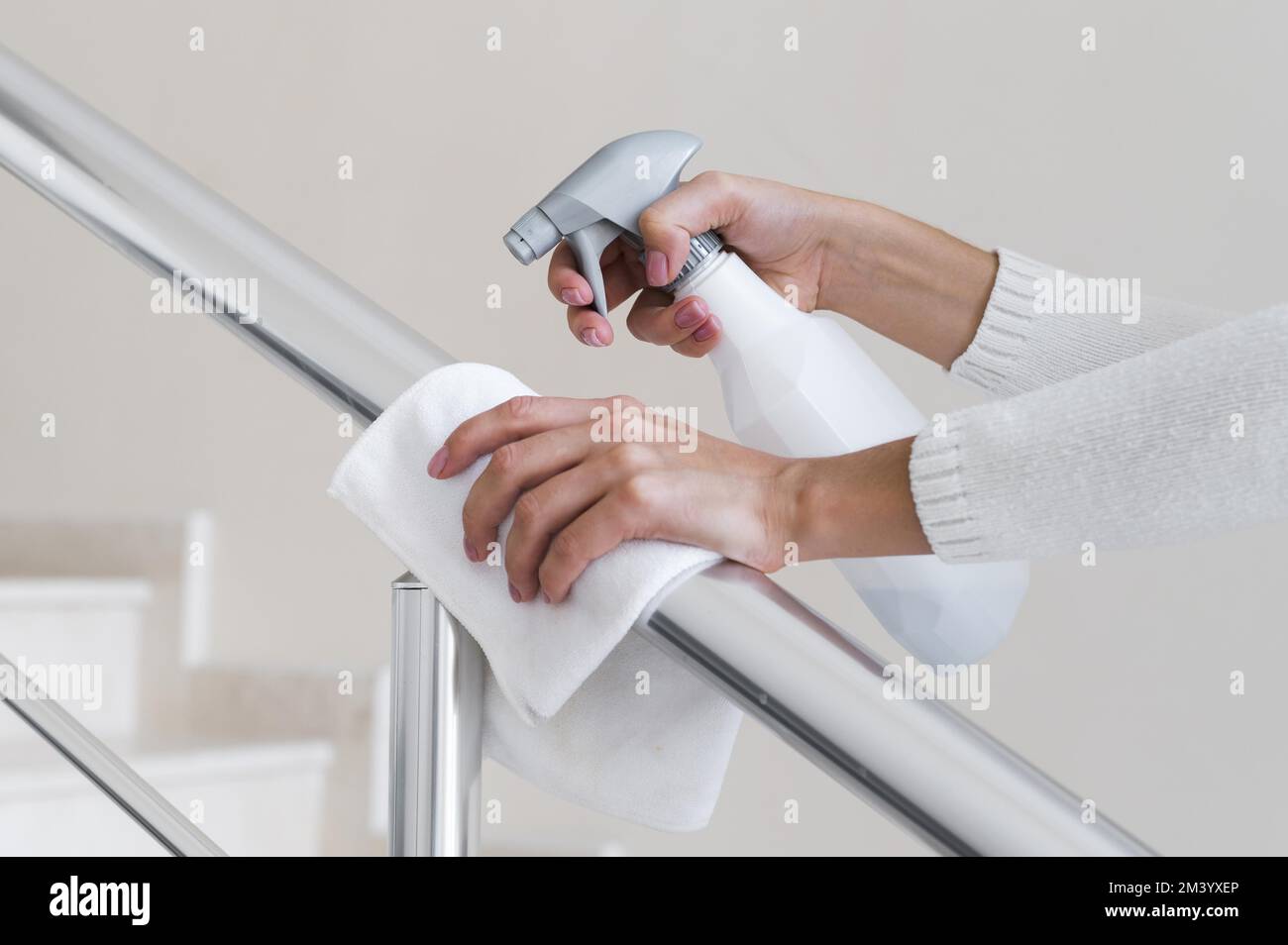Hands disinfecting hand rail Stock Photo - Alamy