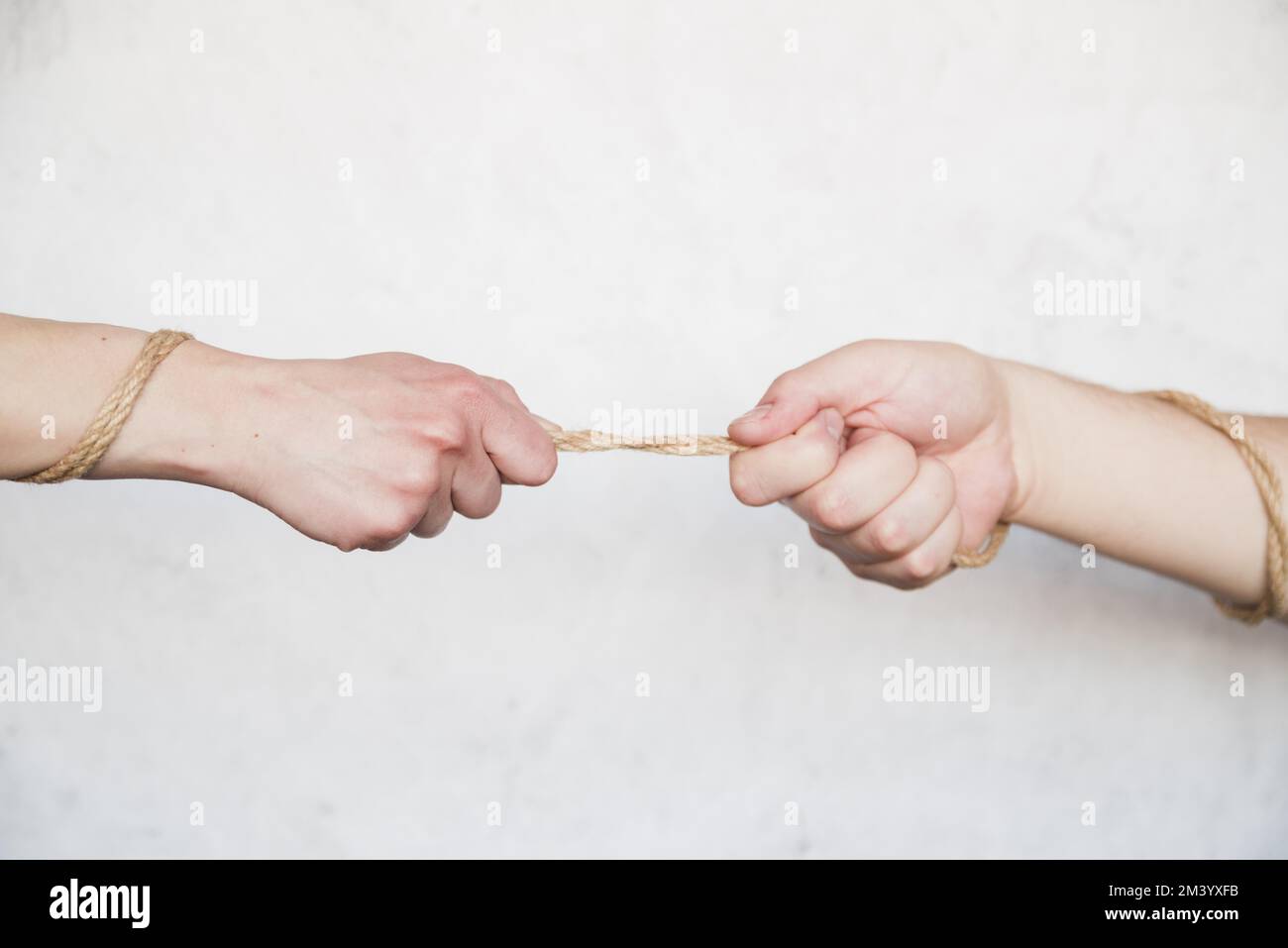 Hands pulling rope Stock Photo - Alamy