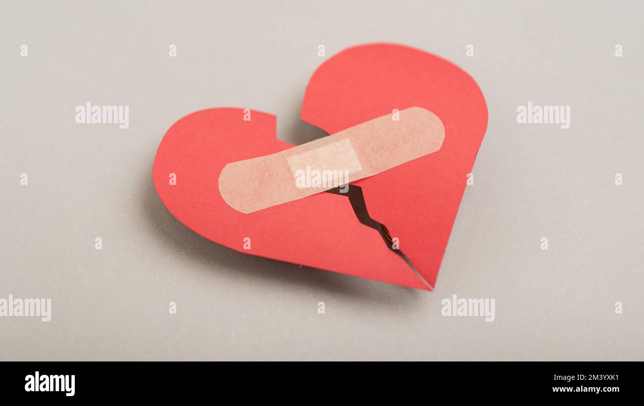High angle broken heart with band aid Stock Photo - Alamy