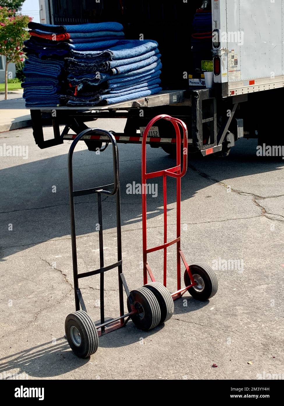 Large oversized moving van preparing to hold a family’s household ...