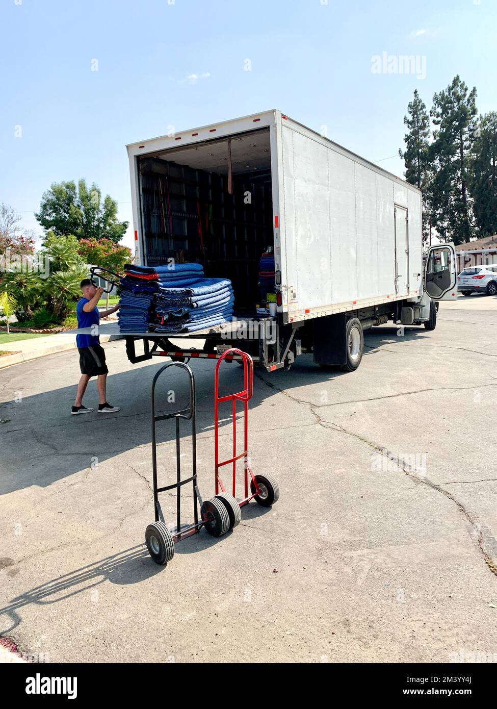 Large oversized moving van preparing to hold a family’s household ...