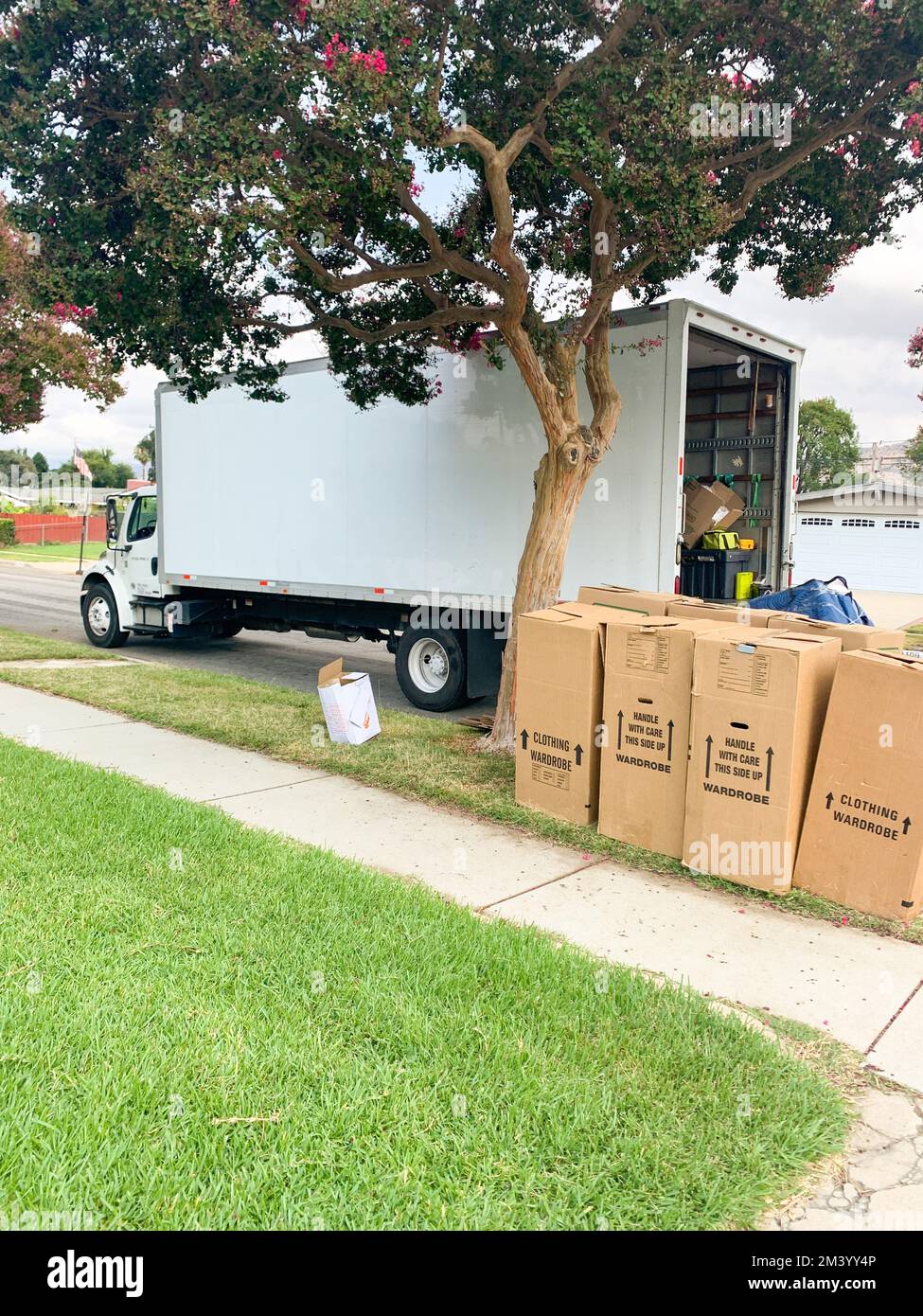 Large oversized moving van preparing to hold a family’s household ...