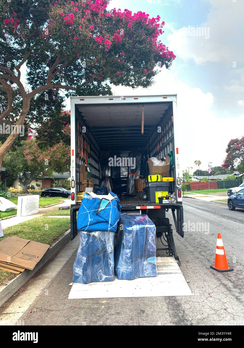 Large oversized moving van preparing to hold a family’s household ...