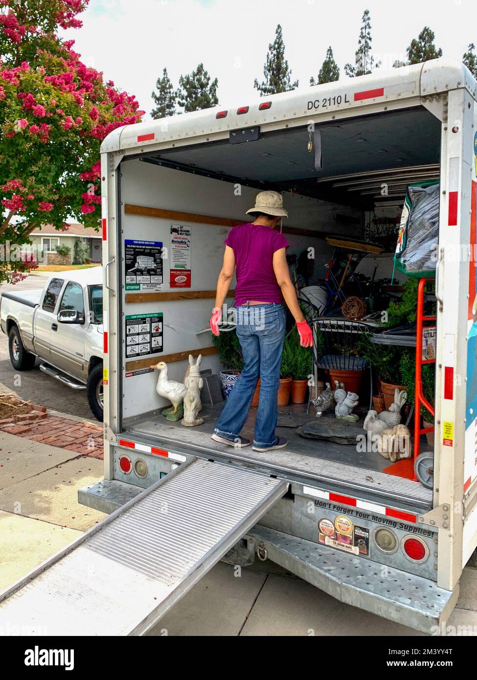Family unloading household furniture items from moving truck Stock Photo - Alamy