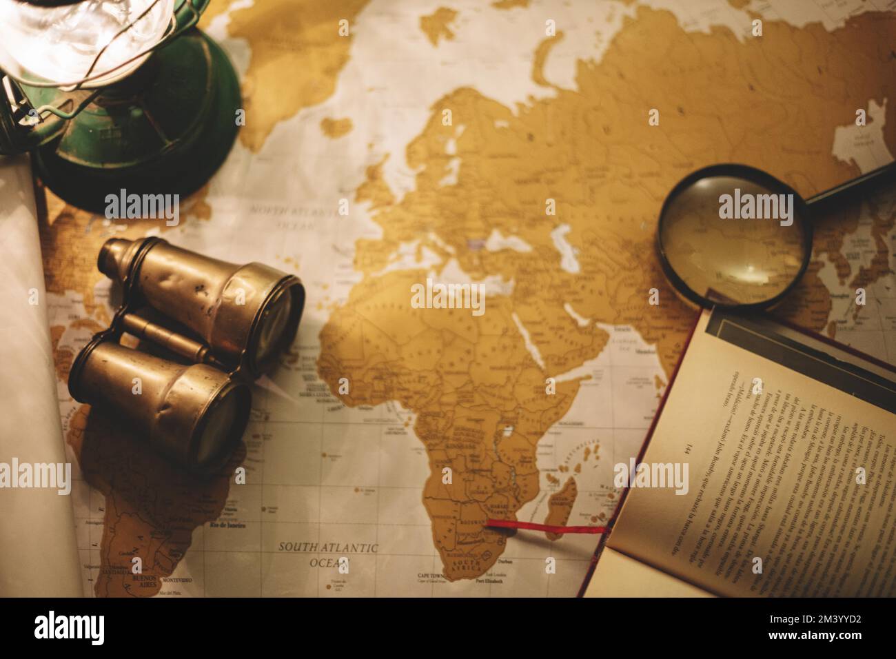 Binoculars magnifying glass map Stock Photo - Alamy