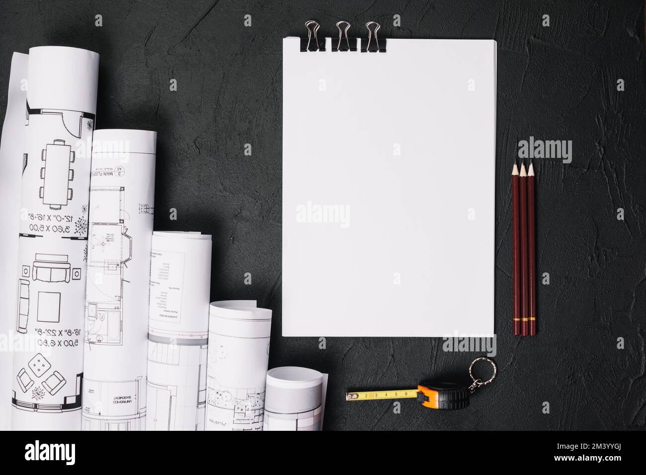 Blank paper with blueprints on table Stock Photo - Alamy