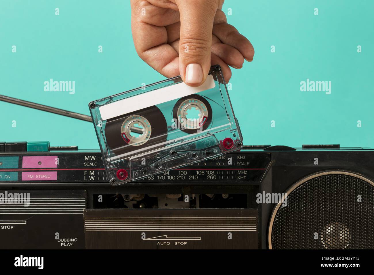 Inserting tape into cassette Stock Photo - Alamy