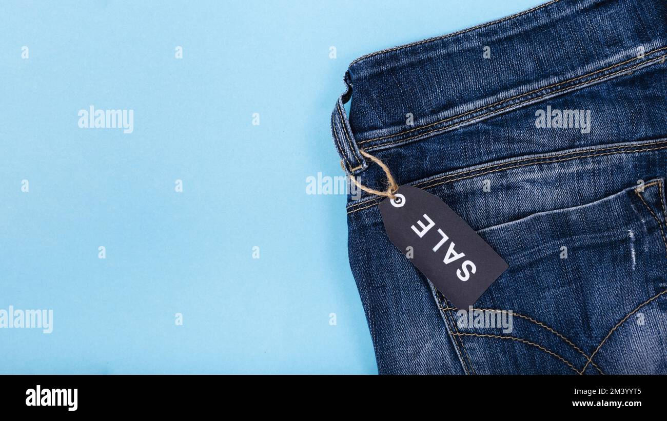 Jeans with black friday tag attached Stock Photo - Alamy