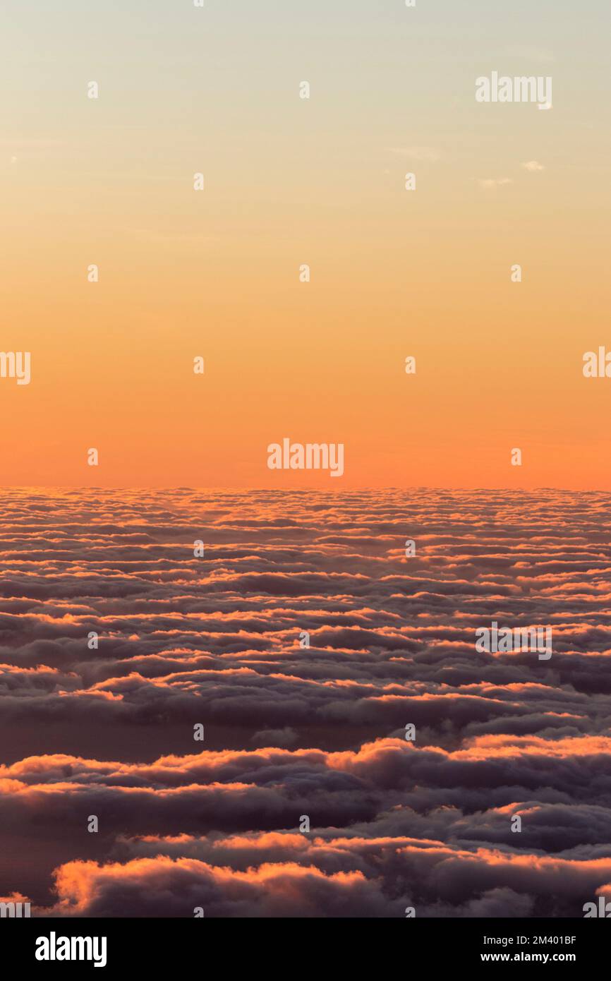 A vertical shot of the colorful and half-cloudy sunset with the view ...
