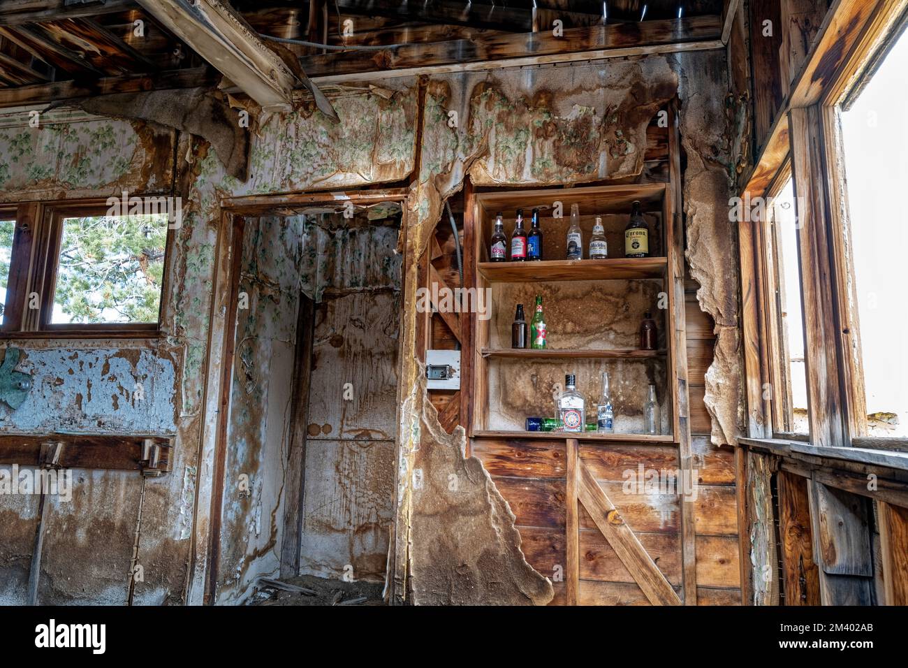 Bottles on the shelves in a broken down shack at an abandoned mine in ...