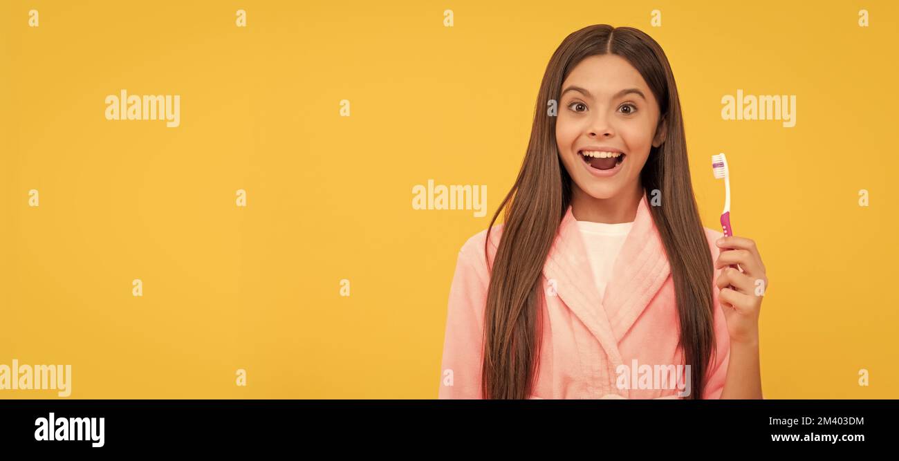 surprised teen girl in home terry bathrobe hold toothbrush, mouth care ...