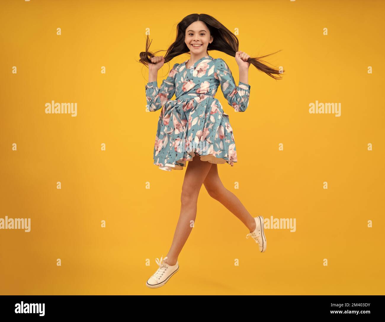 Happiness, freedom, motion and child. Young teenager girl jumping over ...