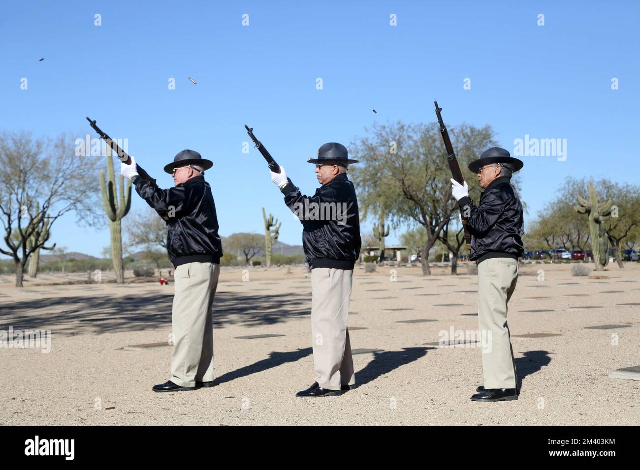 Veterans stand ready to do a 21-gun salute after the ceremony concludes ...