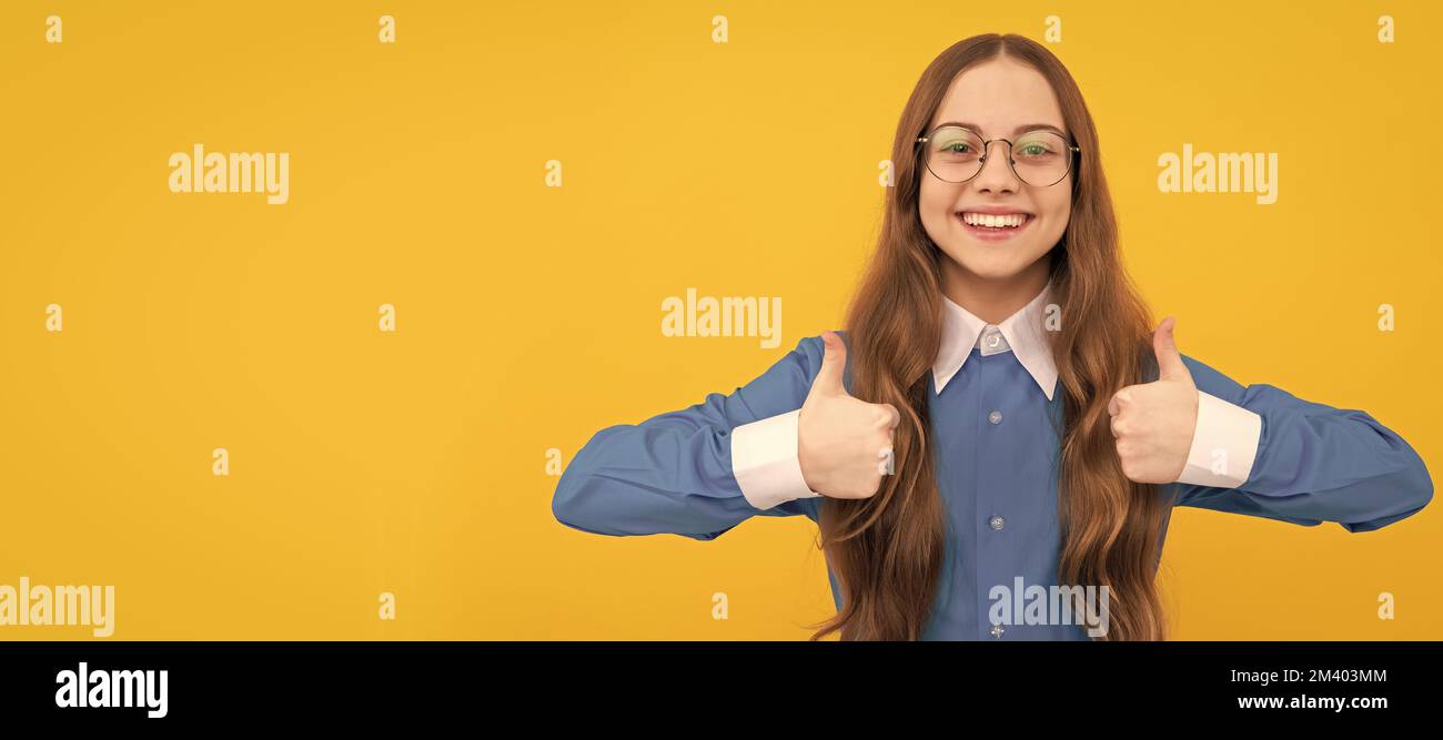 Get education, get satisfaction. Happy teen girl give thumbs ups ...