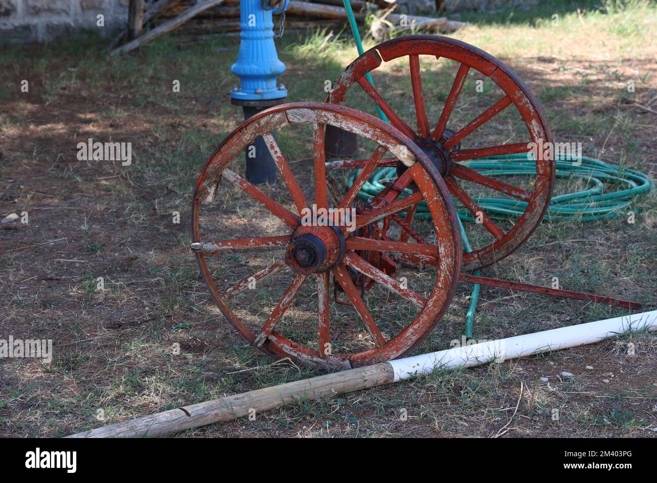 An old and rustic cart wheels on a field Stock Photo - Alamy