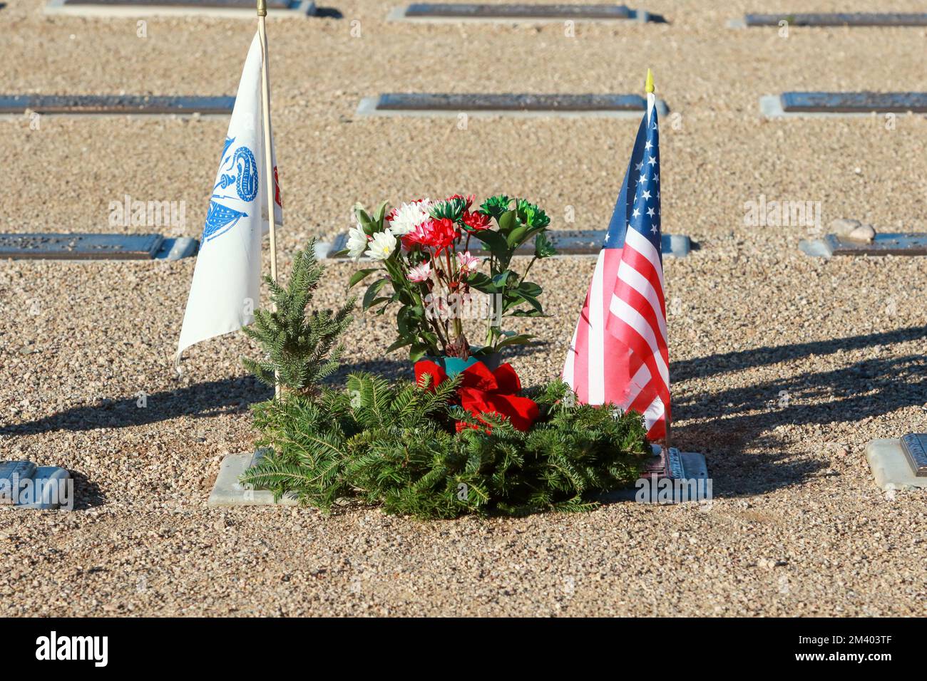 A headstone with a wreath that was laid down for the national Wreaths Across America day which ...