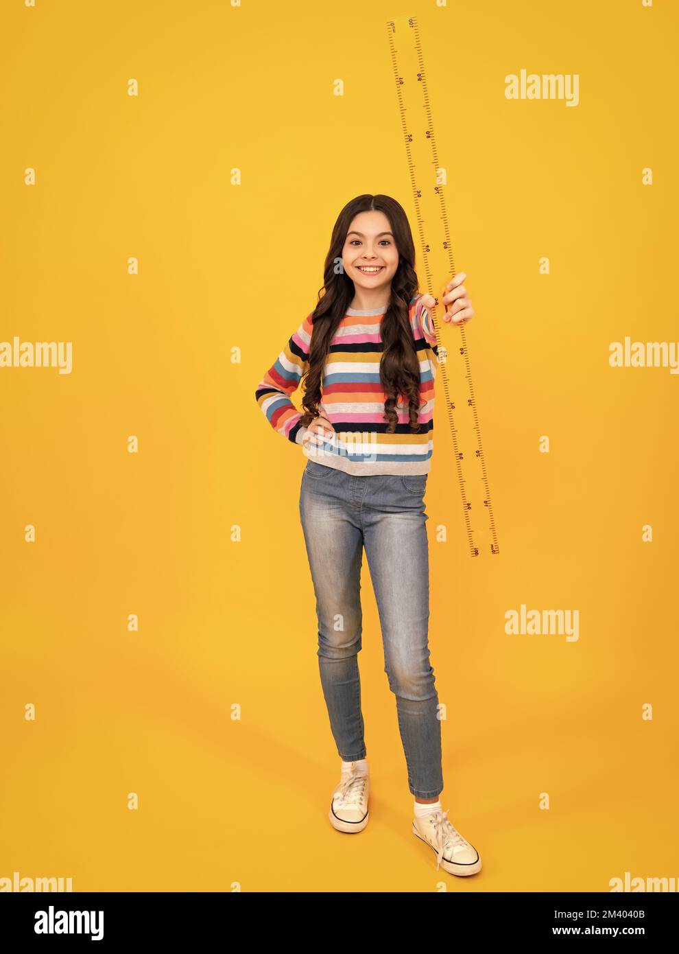 Teenager school girl study math or geometry lesson, measure the size ...