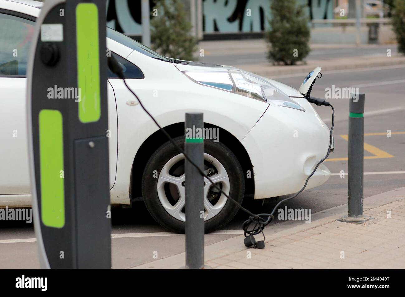 Charging modern electric cars, new energy vehicles, NEV, on the street ...