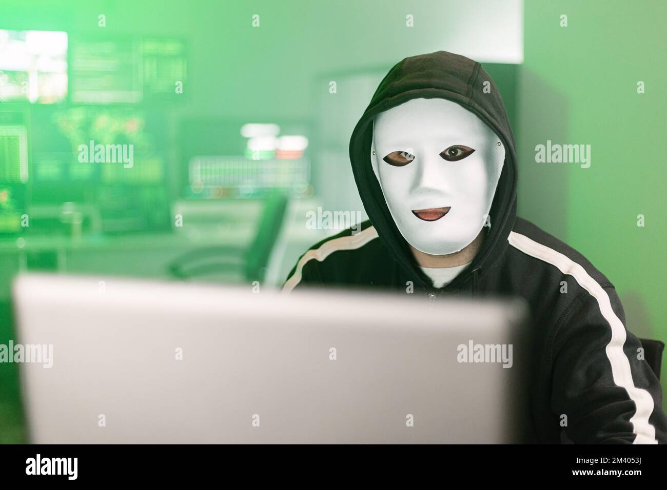 Hacker Working On Laptop Preparing A Cyber Attack In Dark Room Stock