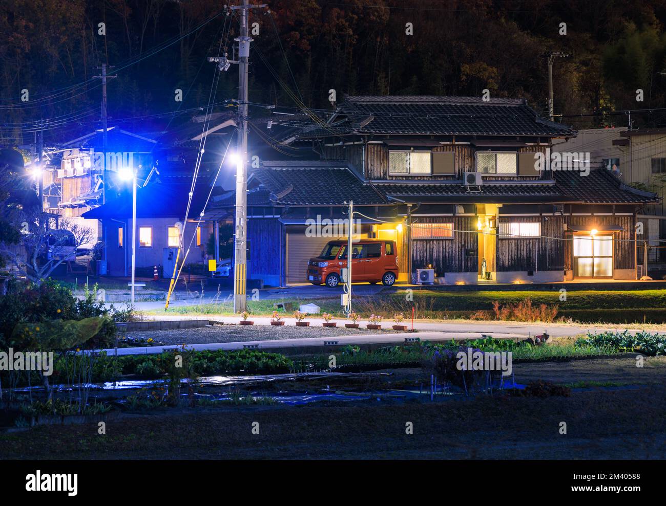 Traditional wooden Japanese house on quiet street country at night ...