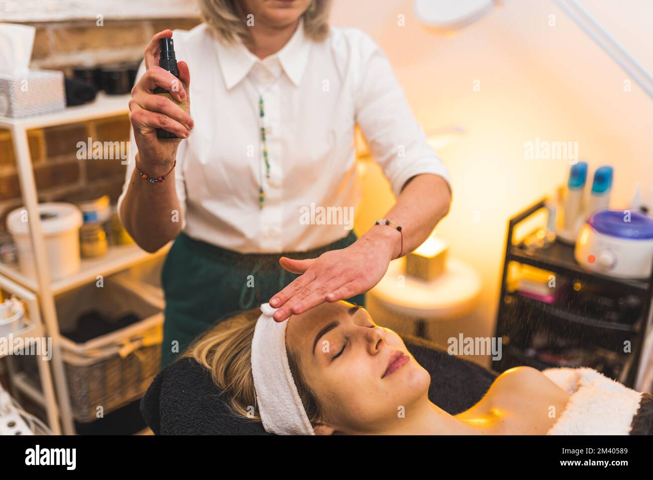 Women spraying mist on face hi-res stock photography and images - Alamy