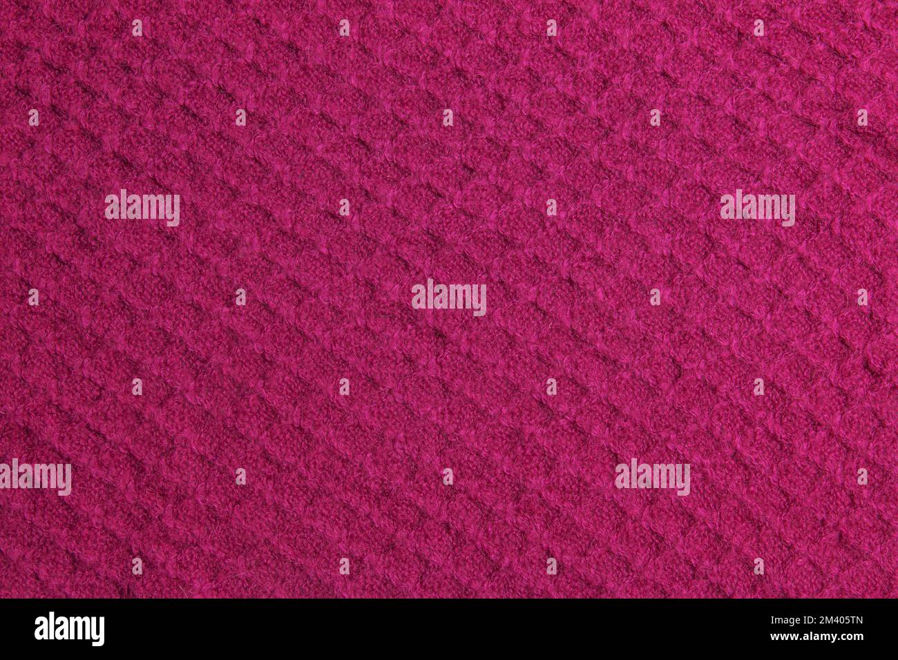 Knitted background in crimson color. Knitted texture of woolen fabric ...