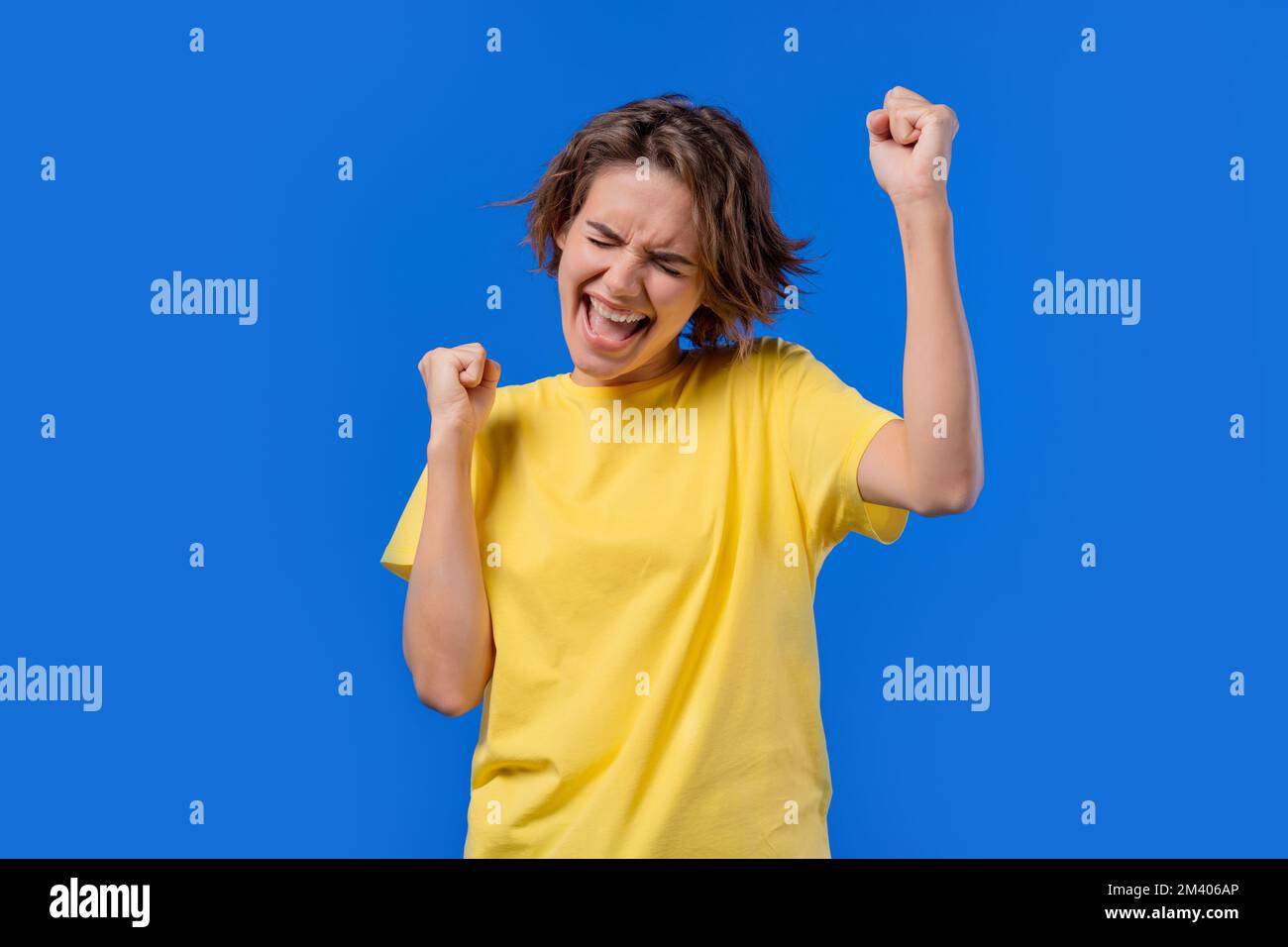 Pretty woman shows triumph yes gesture of victory, she achieved result ...