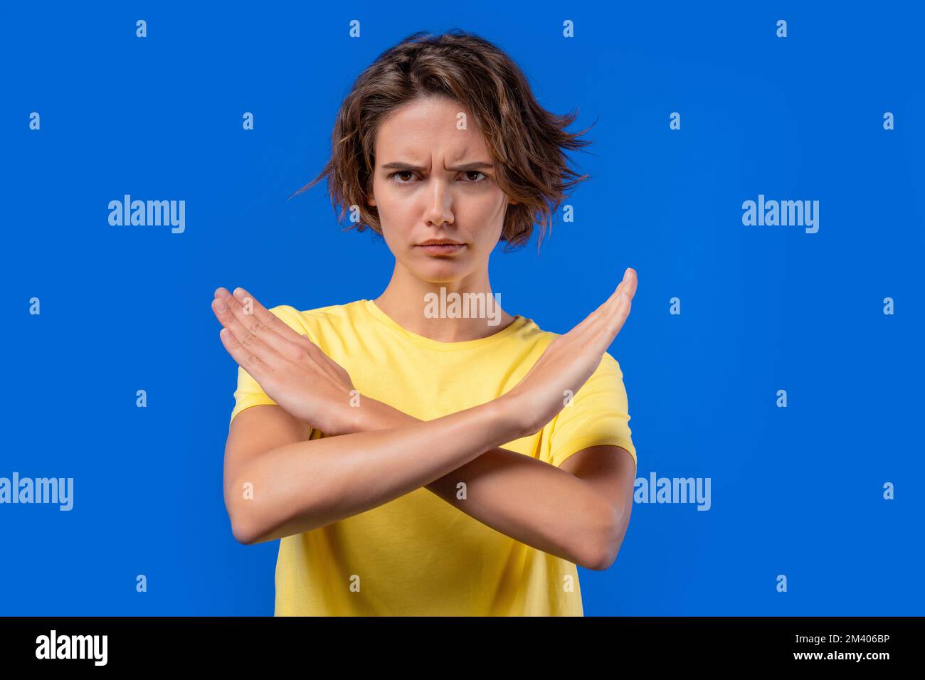Uninterested woman disapproving with NO crossing hands sign gesture ...