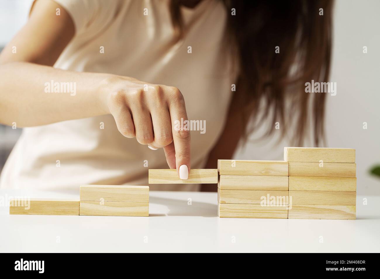Woman hand arranging wood cube stacking as stair step shape Stock Photo ...
