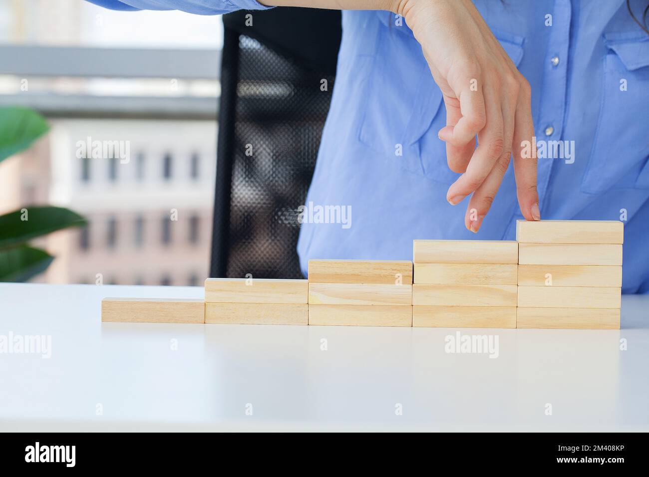 Woman hand stepping up wood block stacking as step stair Stock Photo ...