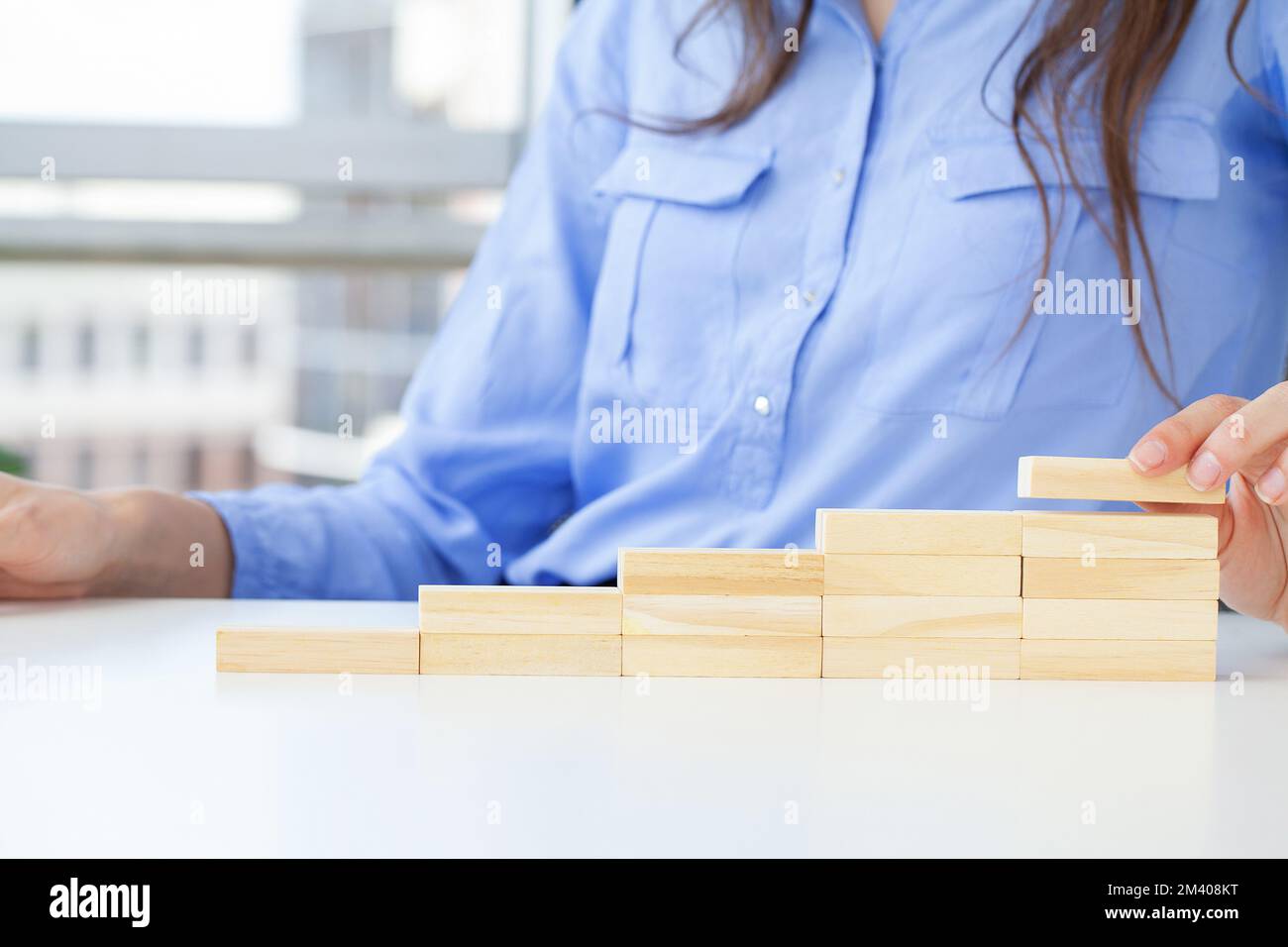 Woman hand of engineer playing a wood block Stock Photo - Alamy