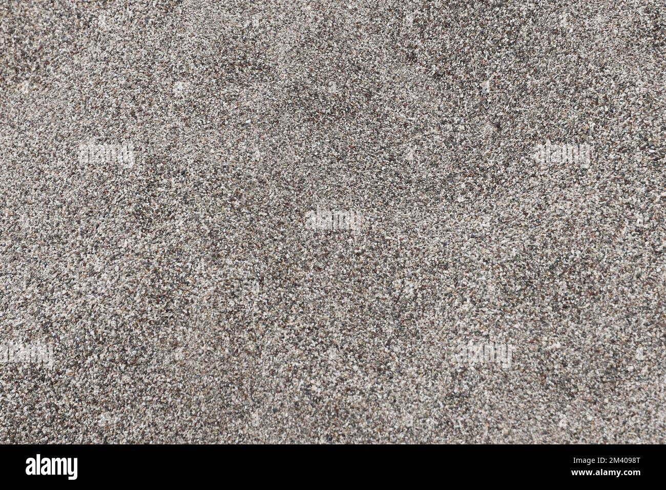 Full frame beach dark sand texture close up in daytime outdoors. Beach ...