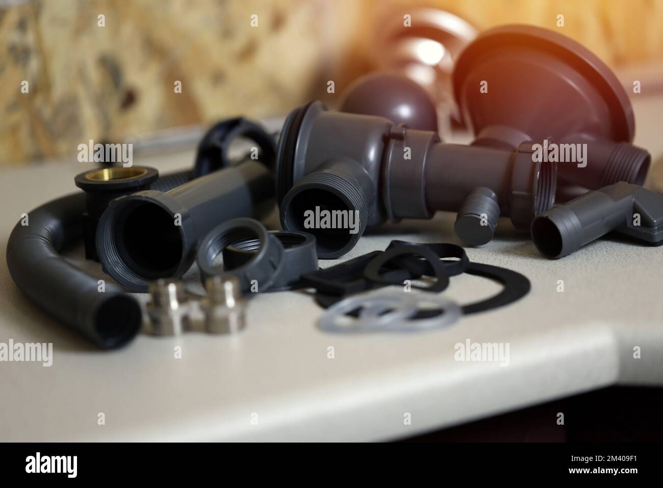 Plumbers tools and water tap ready for installation near sink on ...