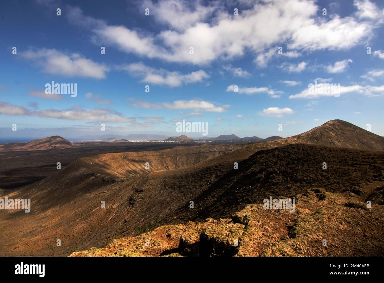 A beautiful scenery of a volcanic landscape with a blue cloudy sky ...