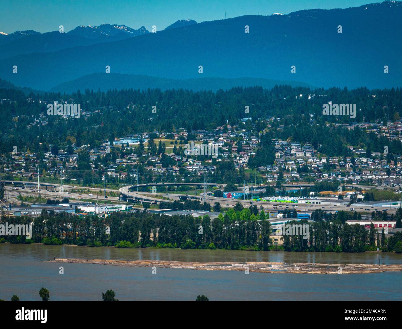 A drone shot of Coquitlam cityscape with Port Mann Bridge and river ...