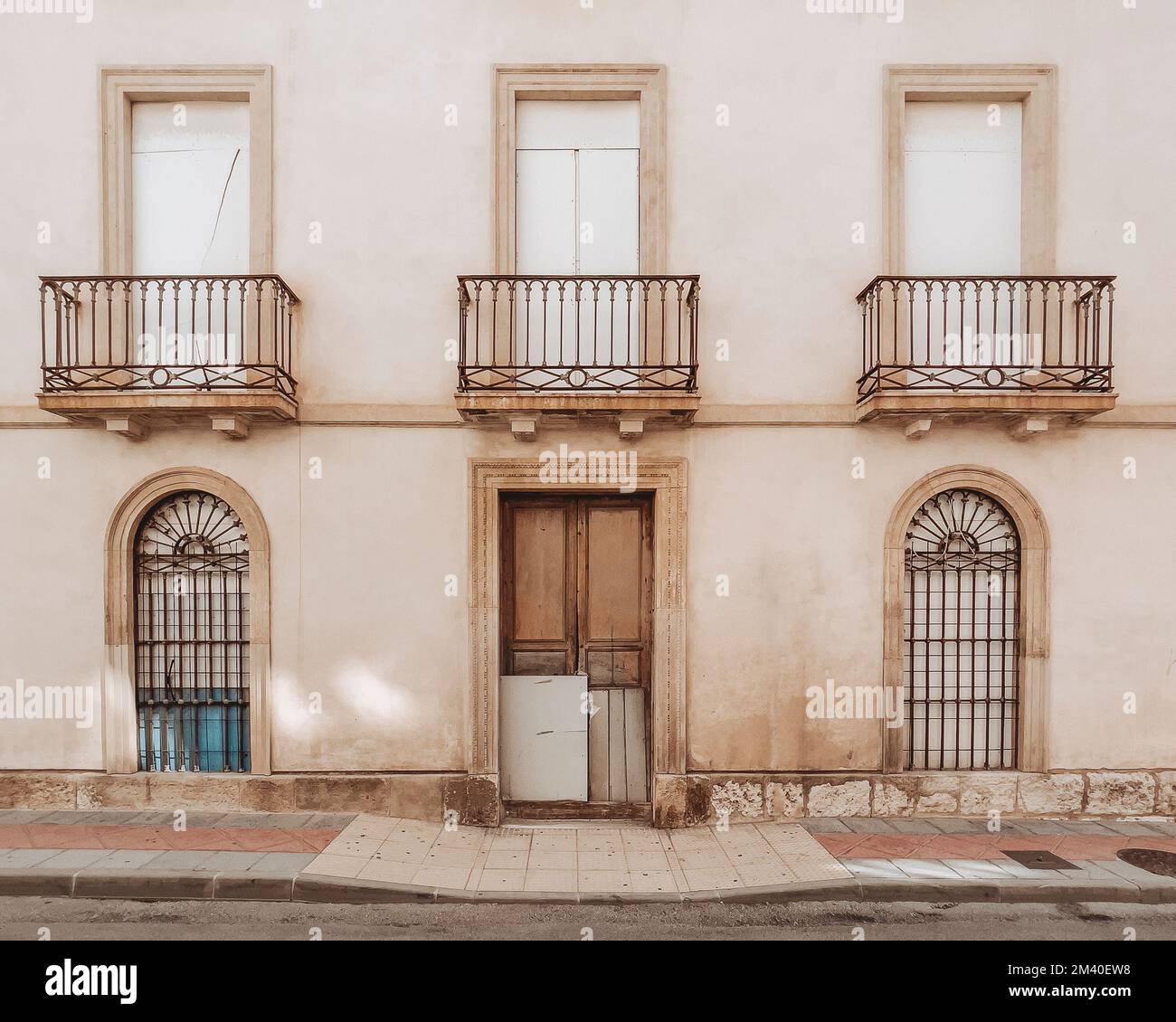 A beautiful exterior view of an old abandoned house, with glassless ...
