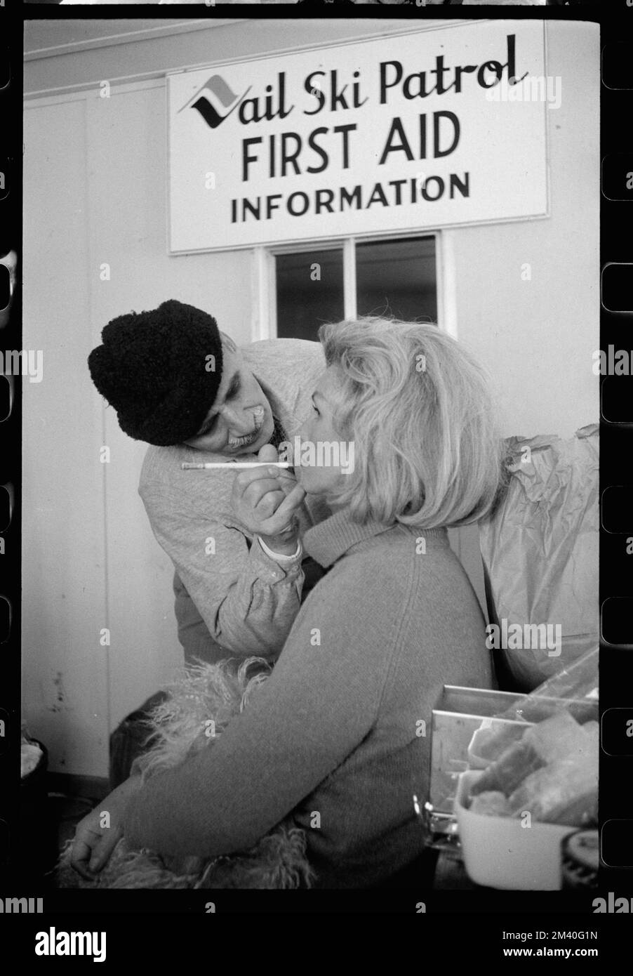 Ann Bonfoey Taylor, seated in chair under sign reading "Vail ski patrol ...