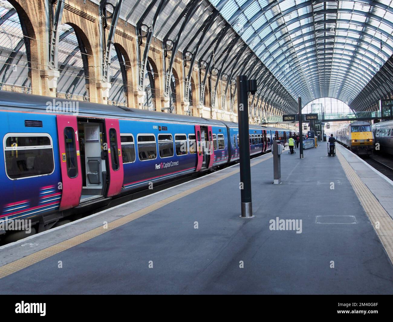 Railway station platform with glass roof, King's Cross, London, England ...